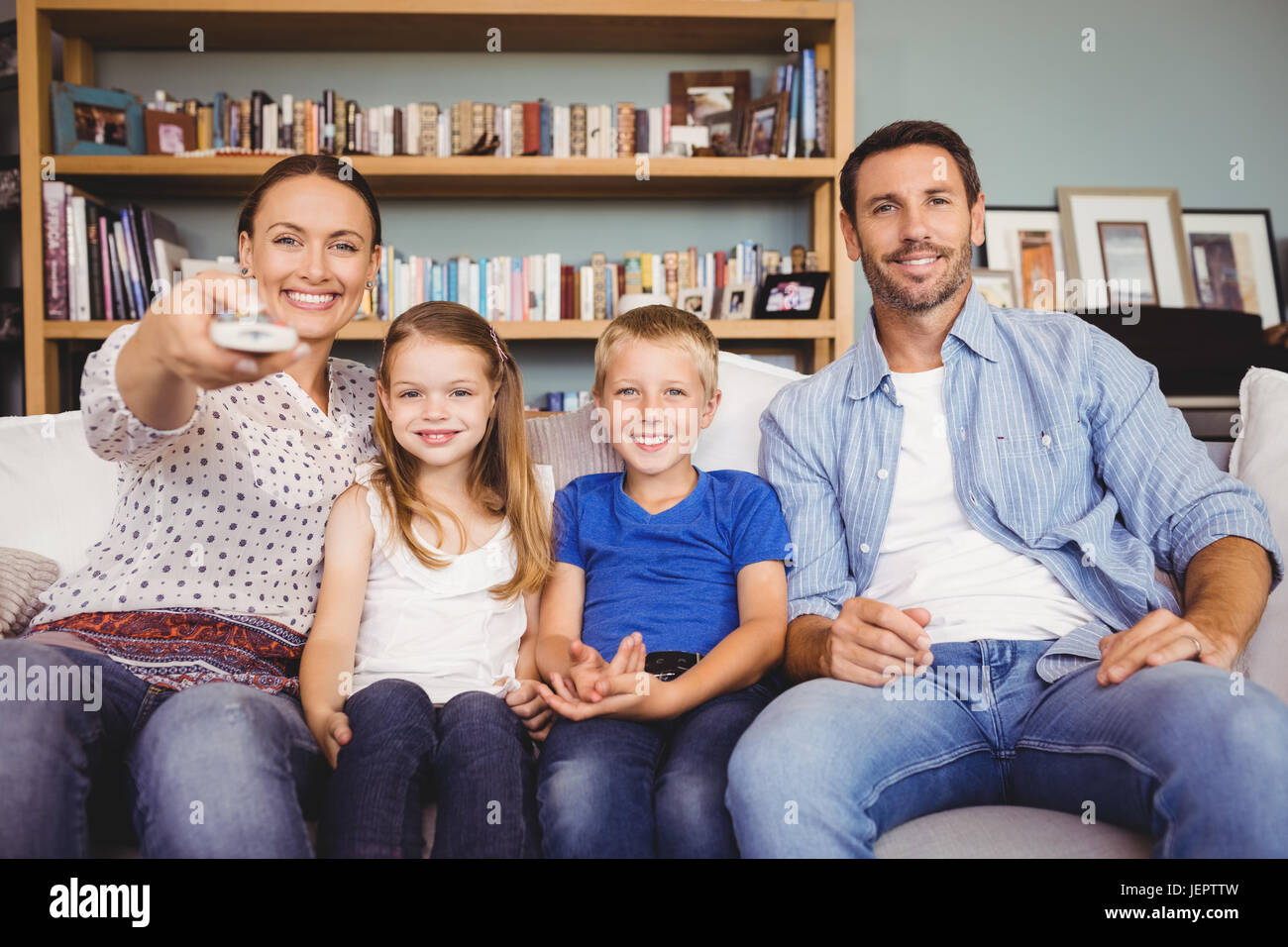 Smiling family watching television Stock Photo - Alamy