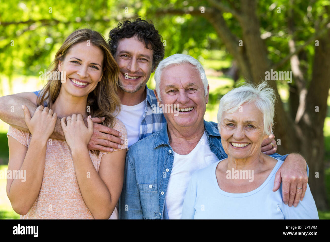 Smiling family hugging Stock Photo - Alamy