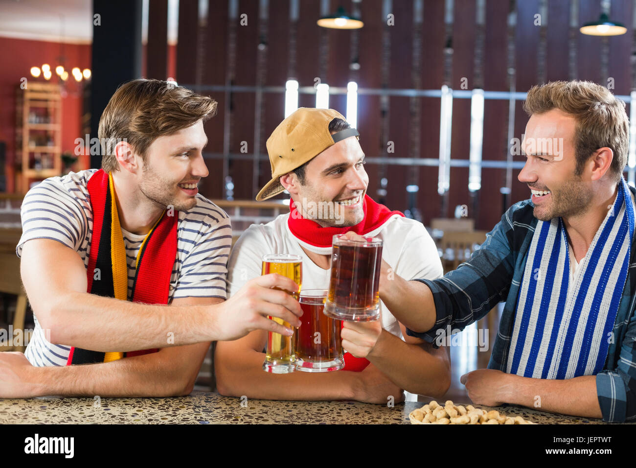 Men toasting with beers Stock Photo - Alamy