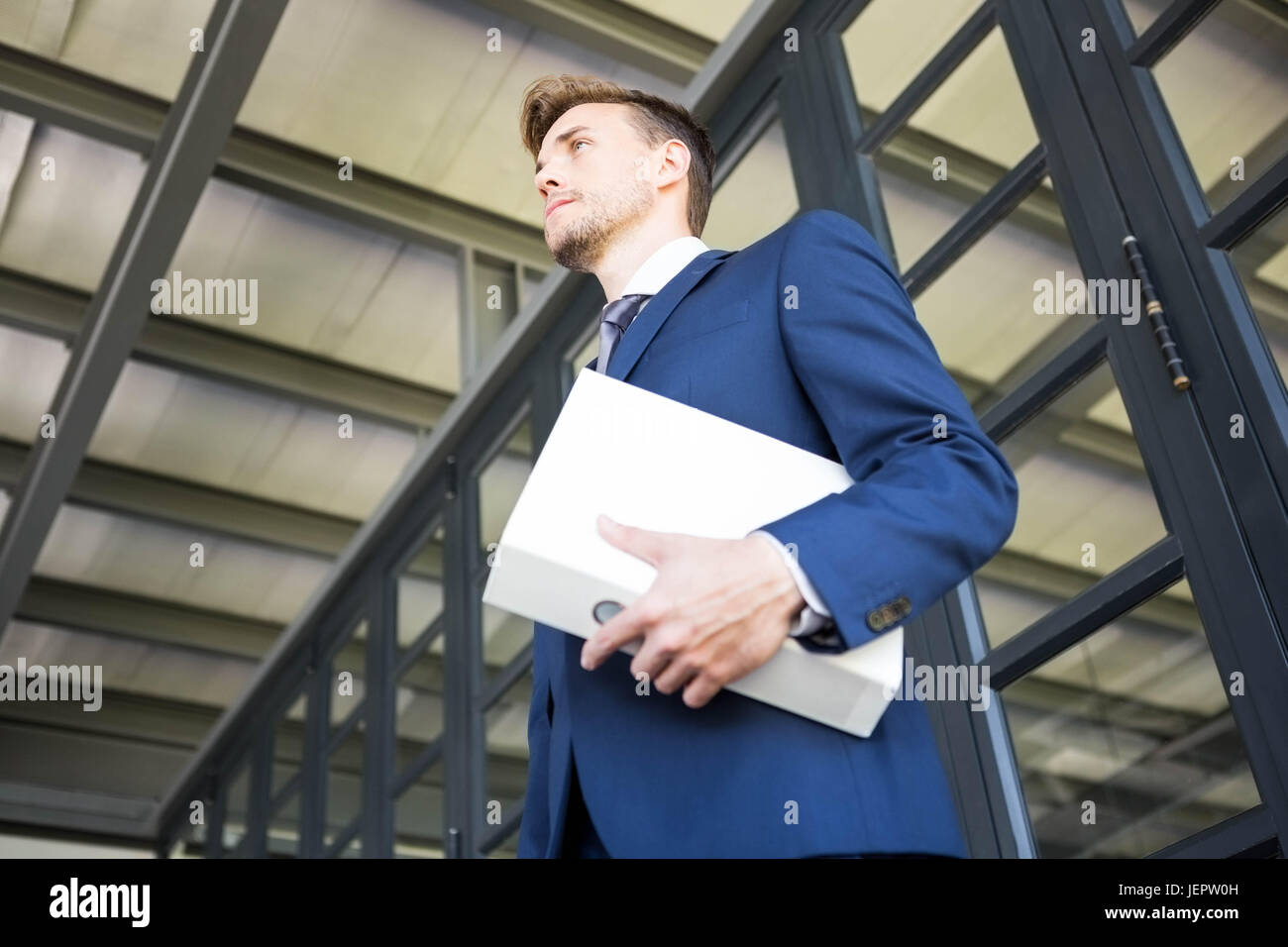 Businessman holding file with documents Stock Photo - Alamy