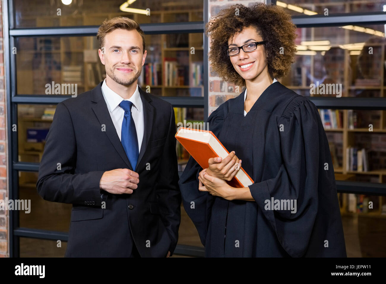 Businessman standing with lawyer near library Stock Photo - Alamy