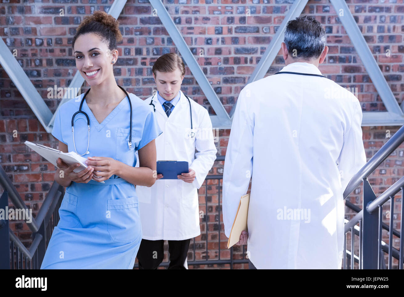 Doctors walking on staircase Stock Photo - Alamy