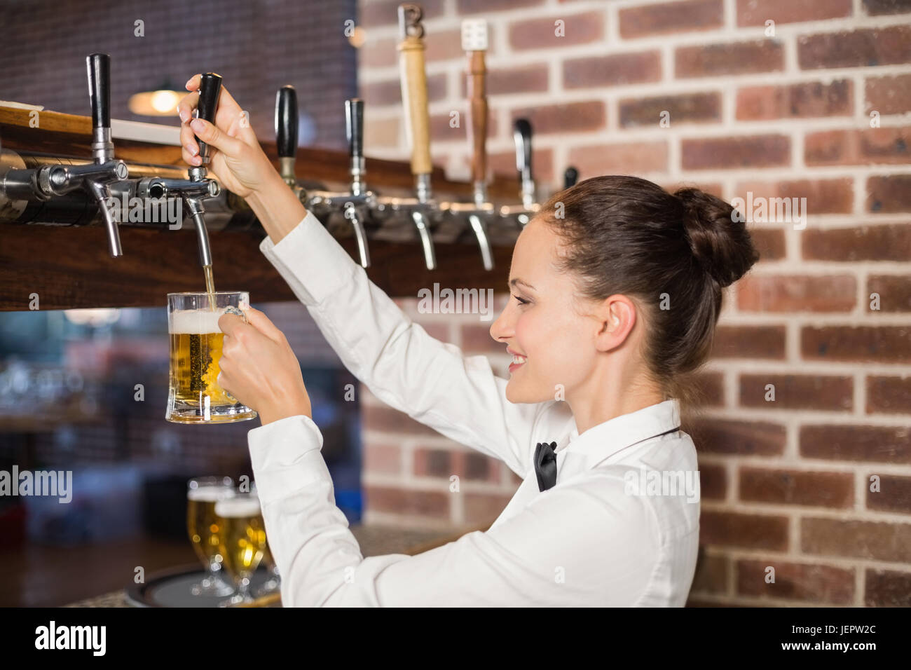 Barmaid pouring pint hi-res stock photography and images - Alamy
