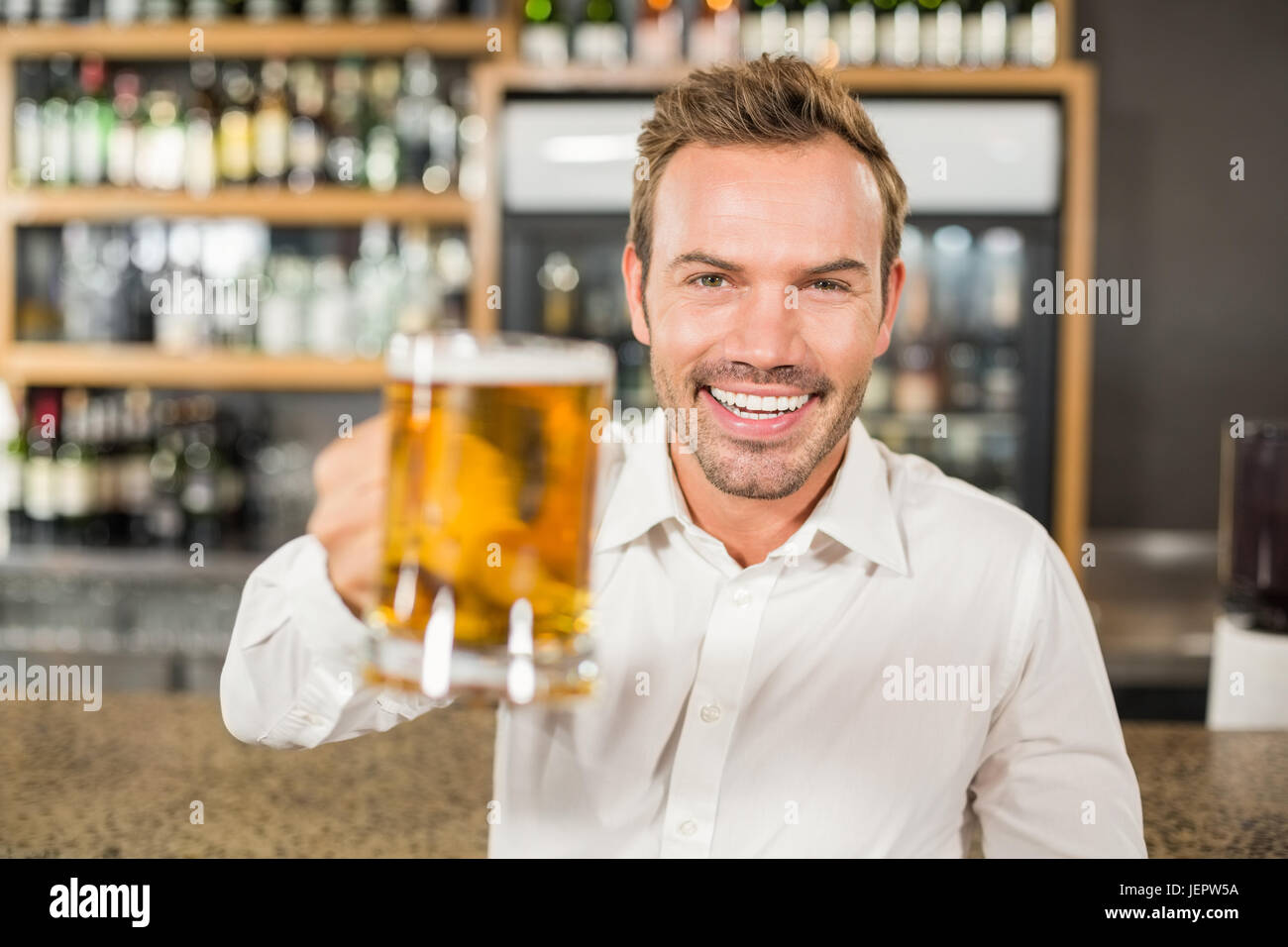 Handsome man toasting Stock Photo - Alamy