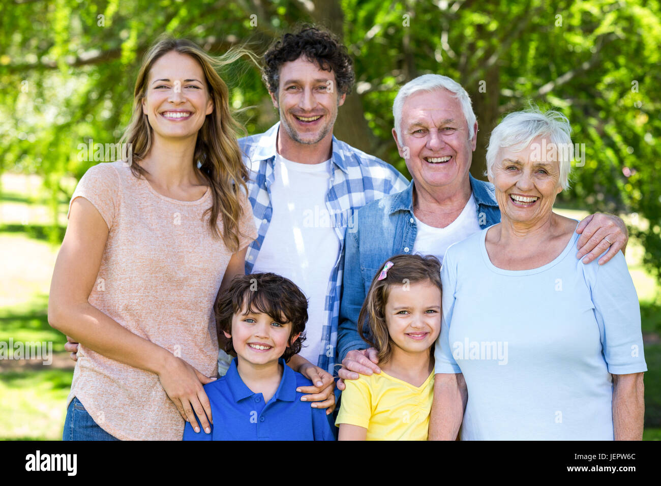 Smiling family hugging Stock Photo - Alamy