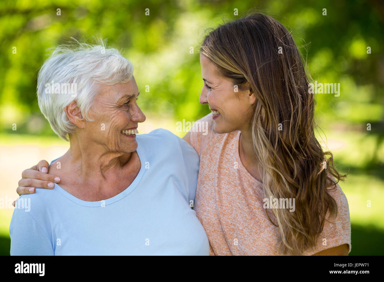 Family standing and smiling Stock Photo - Alamy