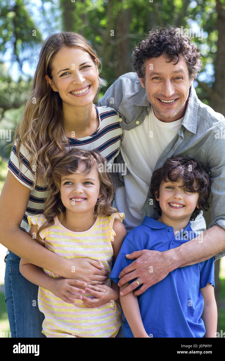 Smiling family standing Stock Photo - Alamy