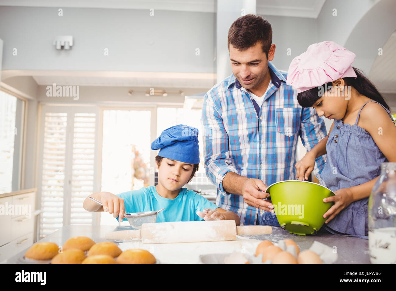 Children helping father in preparing food Stock Photo - Alamy