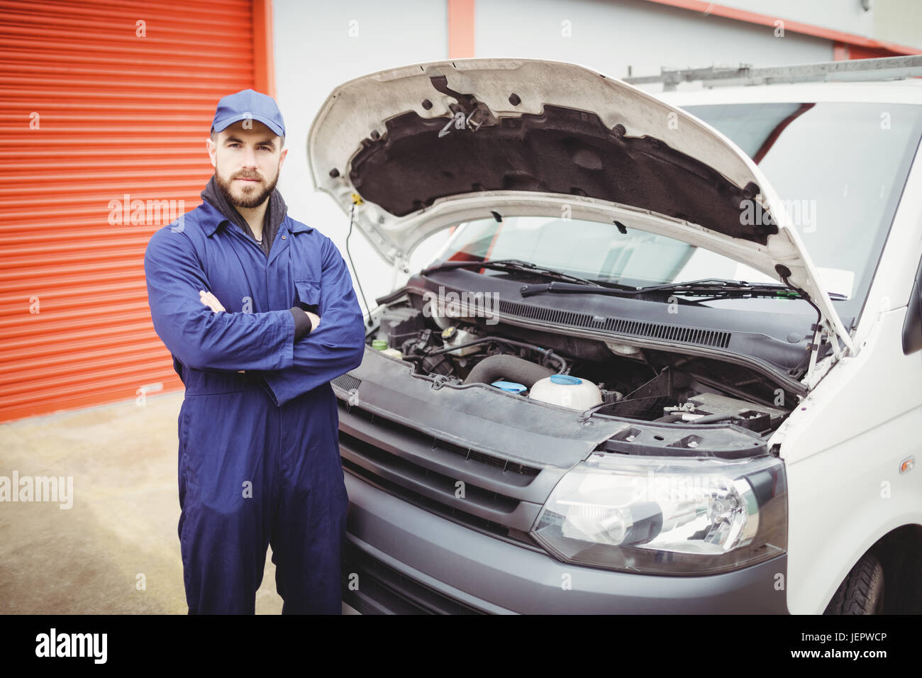 Mechanic with arms crossed Stock Photo - Alamy