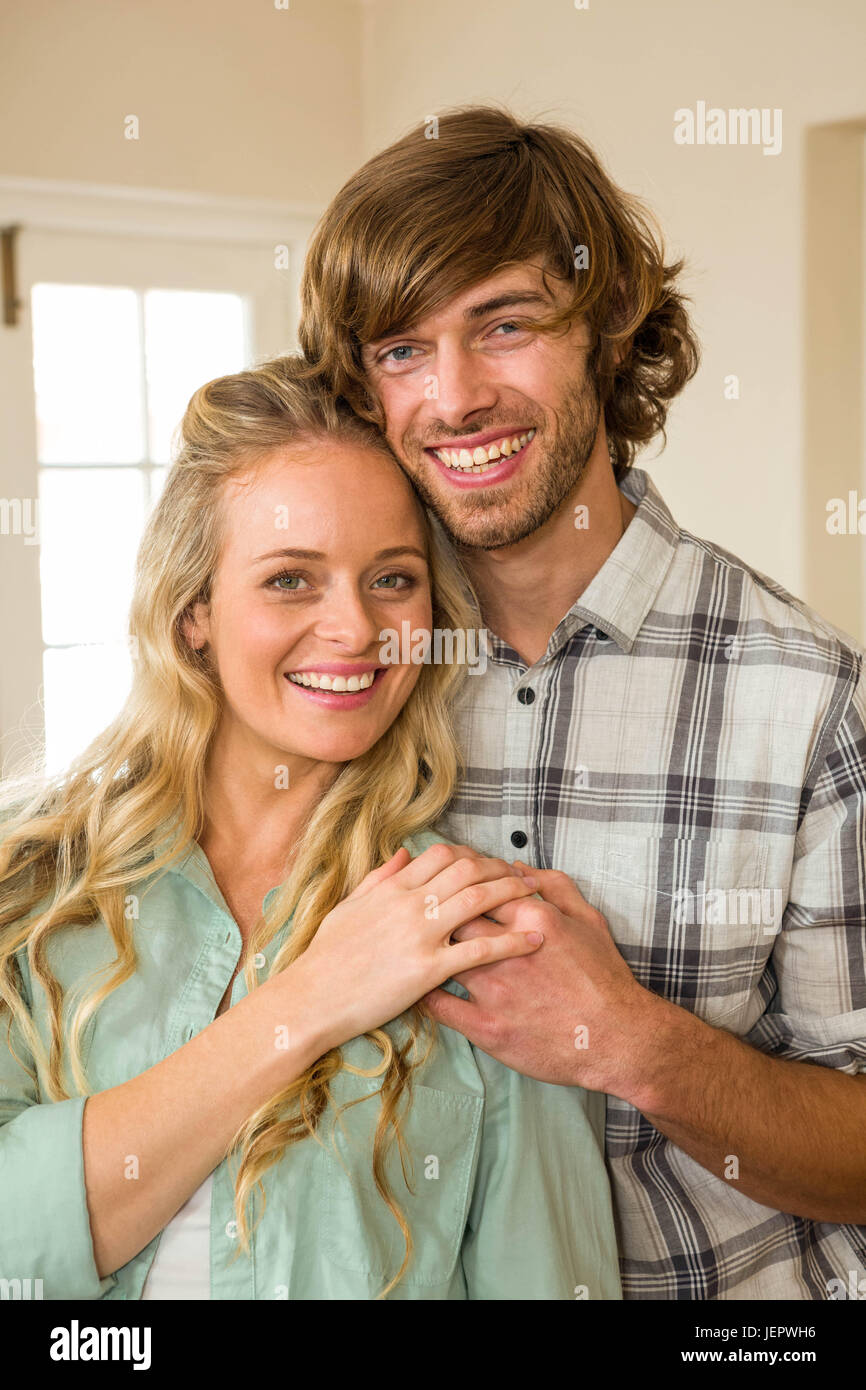 Cute couple hugging with arms around Stock Photo - Alamy