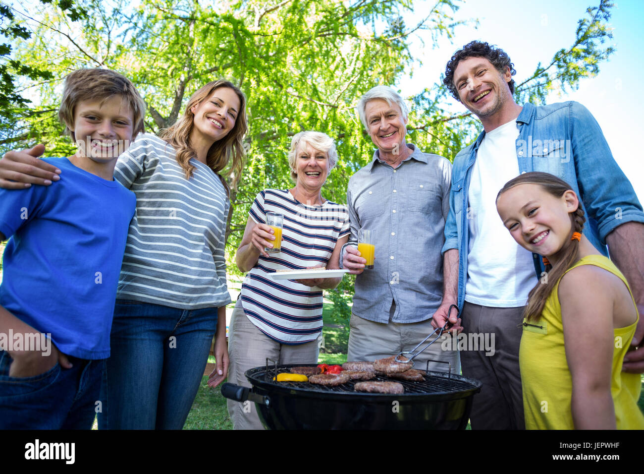 Family having a barbecue Stock Photo - Alamy
