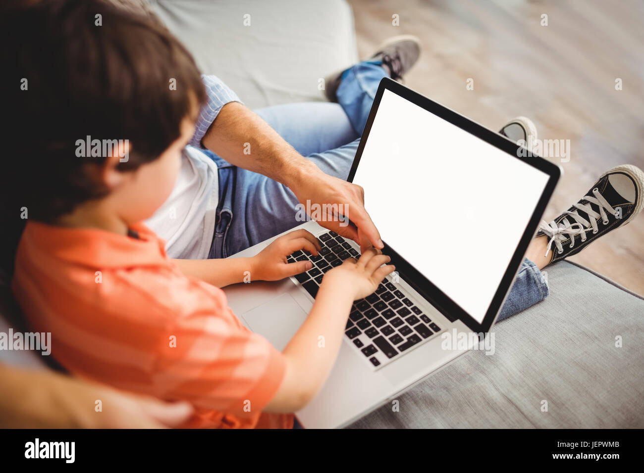 Father and son working on laptop Stock Photo - Alamy