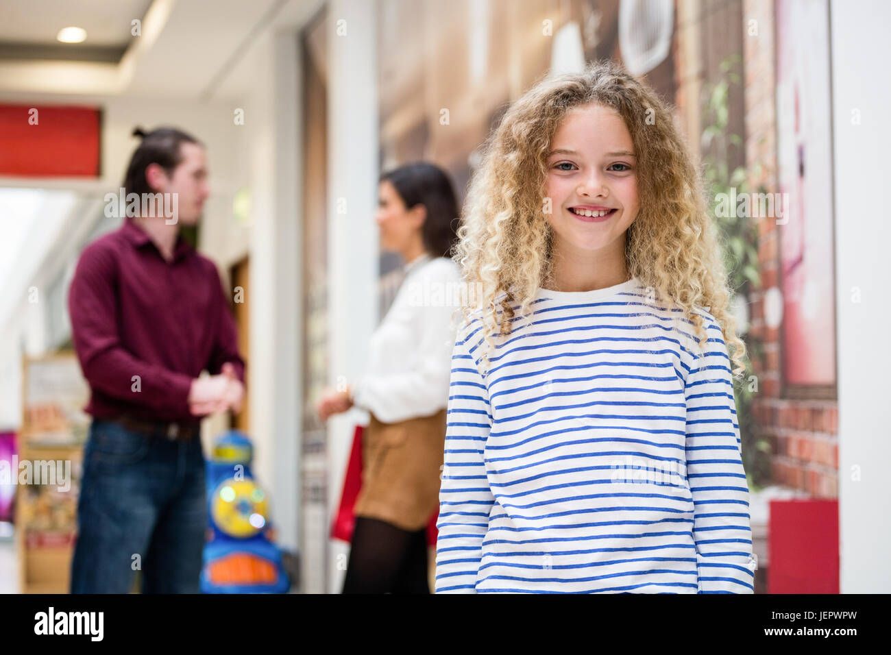 Portrait of happy girl in mall Stock Photo - Alamy
