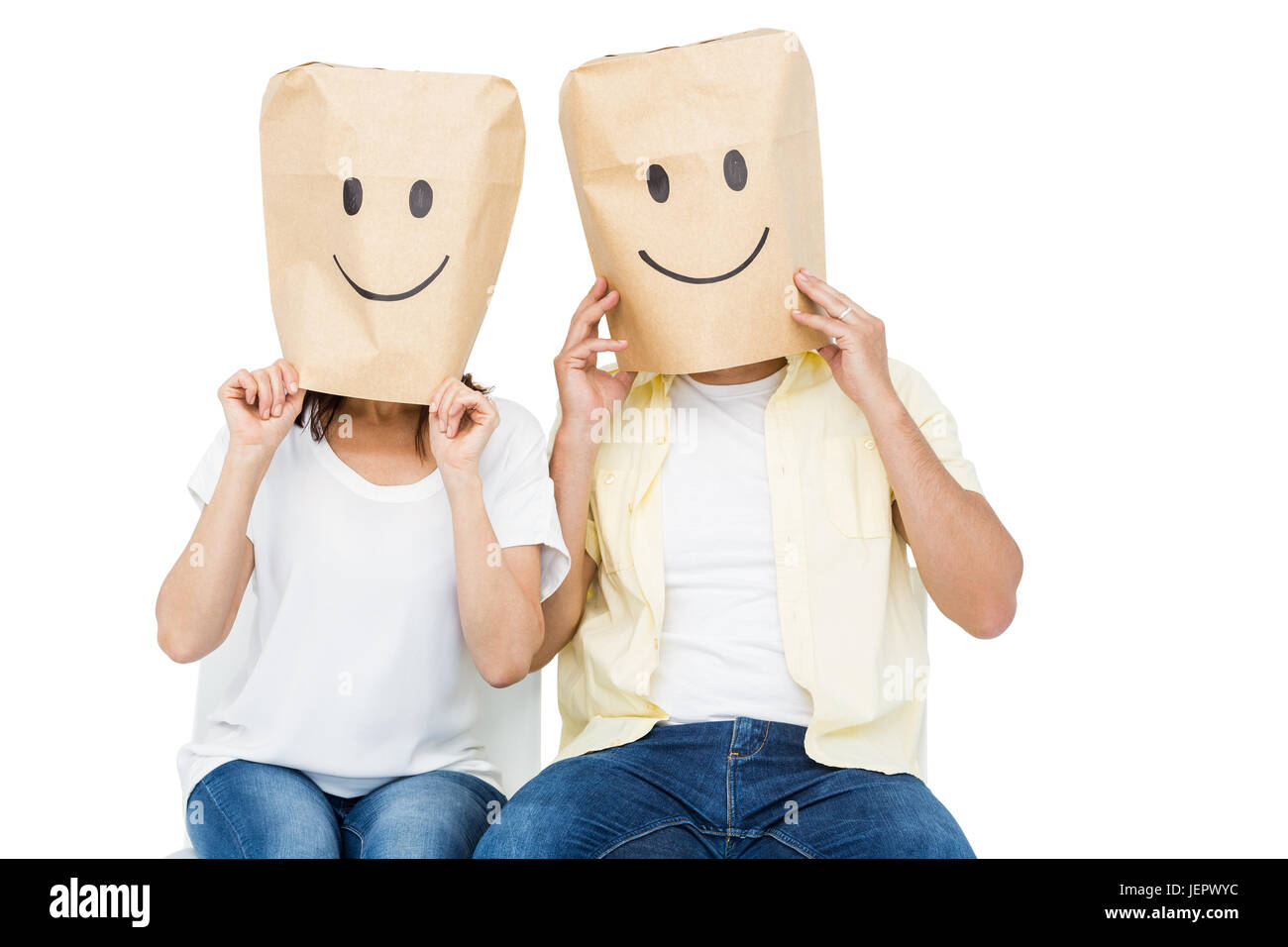 Couple covering their faces with paper bag Stock Photo - Alamy