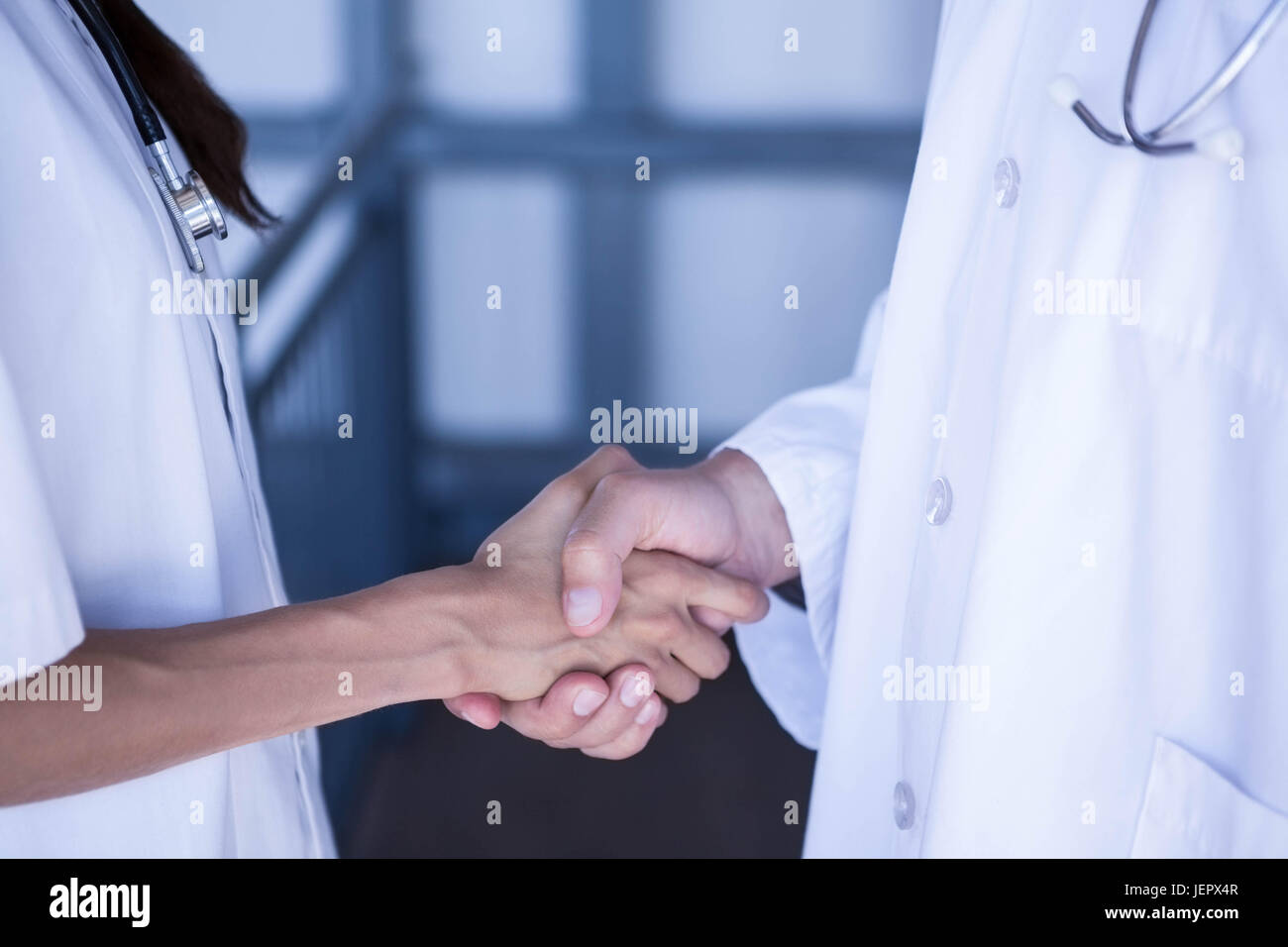 Mid section of doctors shaking hands Stock Photo - Alamy