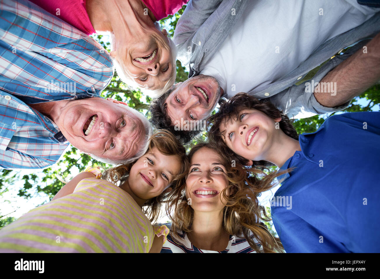 Smiling family with their heads in a circle Stock Photo - Alamy