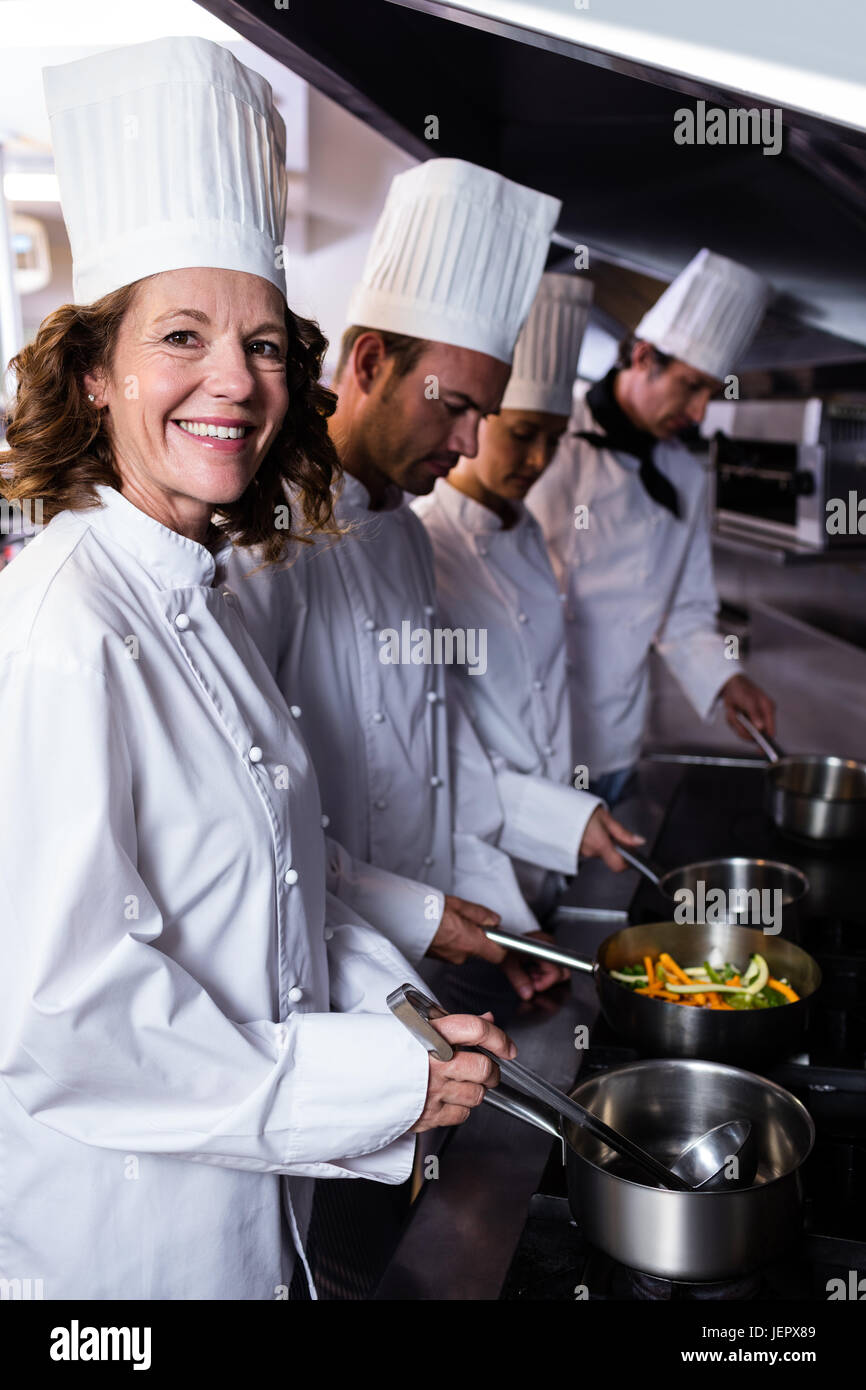 Chefs preparing food in kitchen Stock Photo - Alamy
