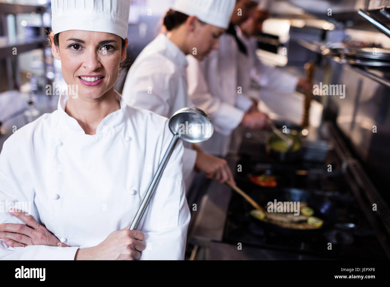 Portrait of chef holding a ladle Stock Photo - Alamy