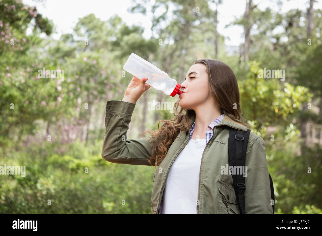 Woman drinking water backpack hi-res stock photography and images - Alamy