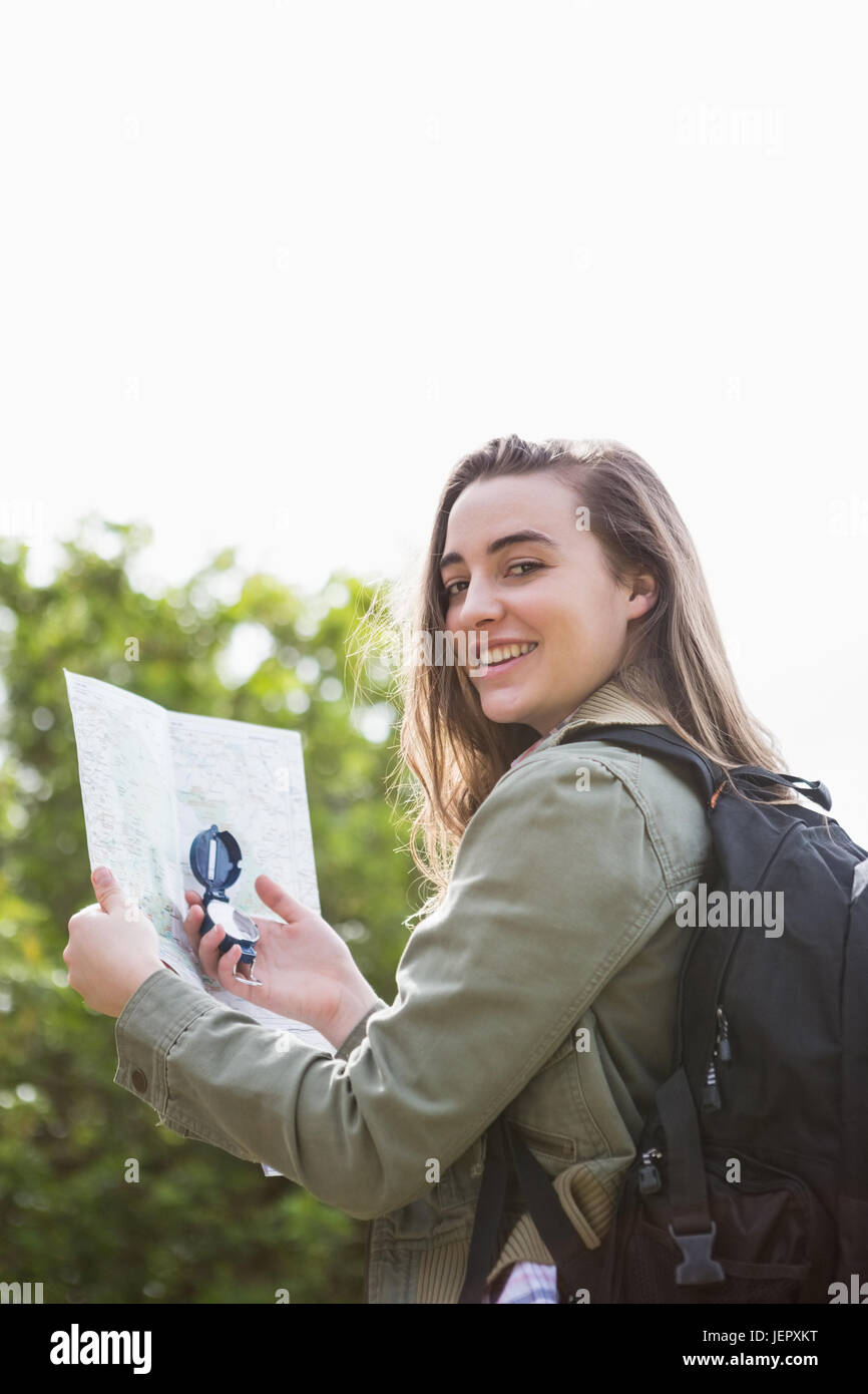 Woman using map and compass Stock Photo - Alamy