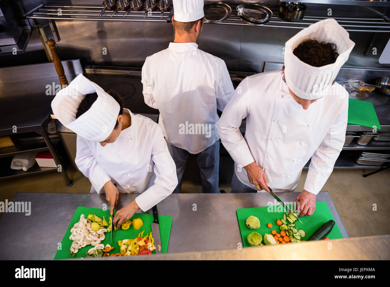 Team of chefs chopping vegetables Stock Photo - Alamy