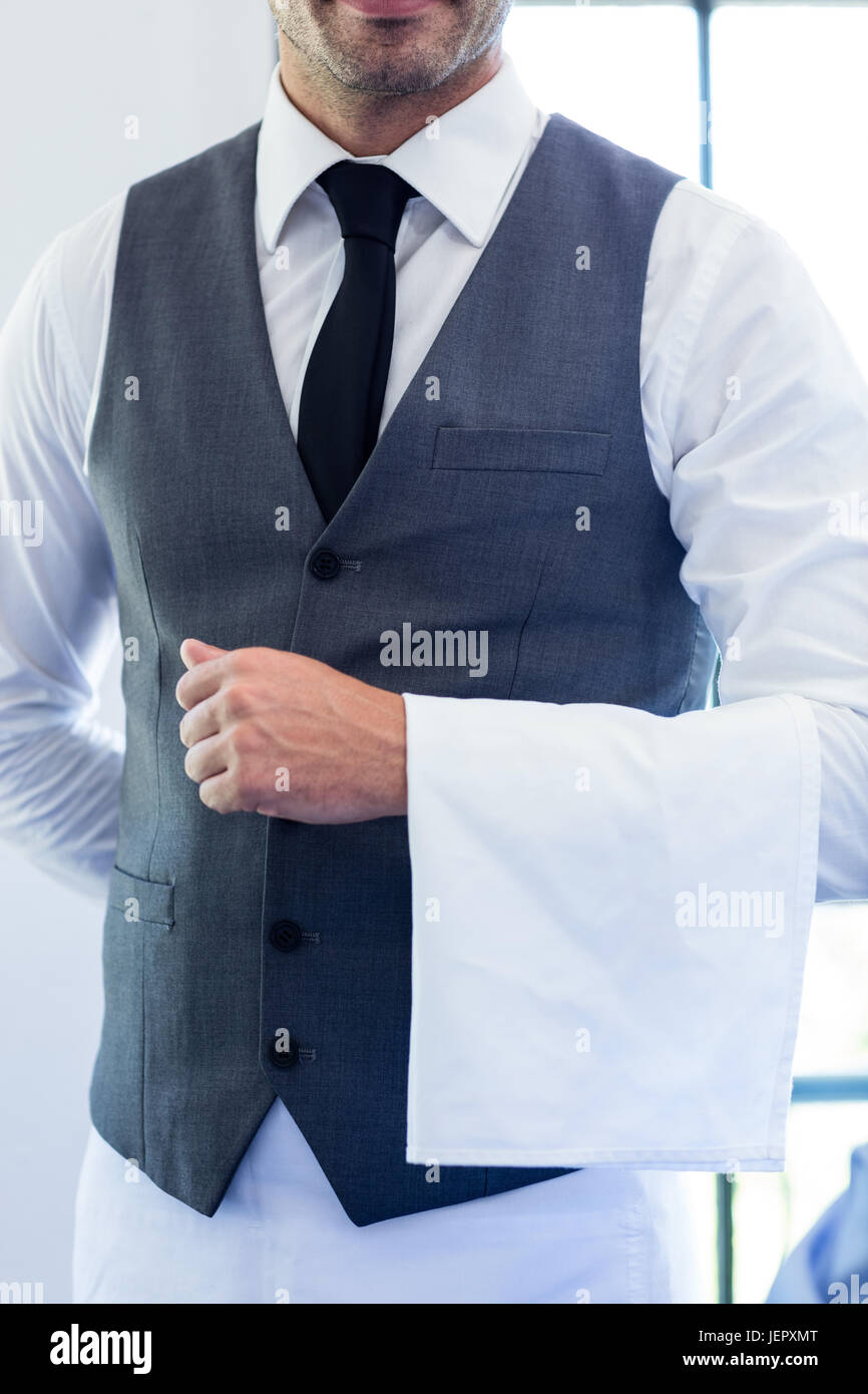Close-up of waiter standing with napkin Stock Photo - Alamy