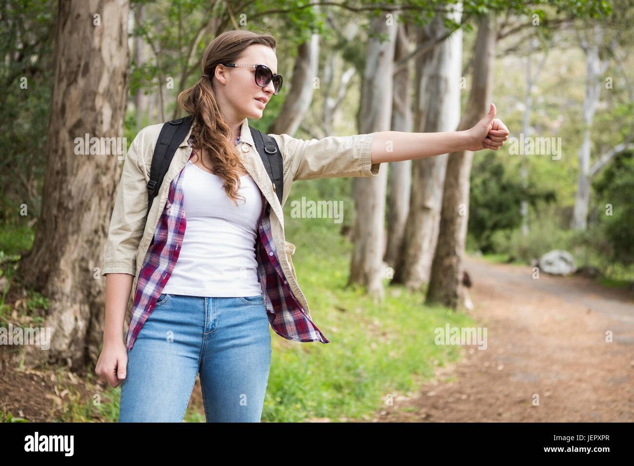 Portrait of woman hitch hiking Stock Photo - Alamy
