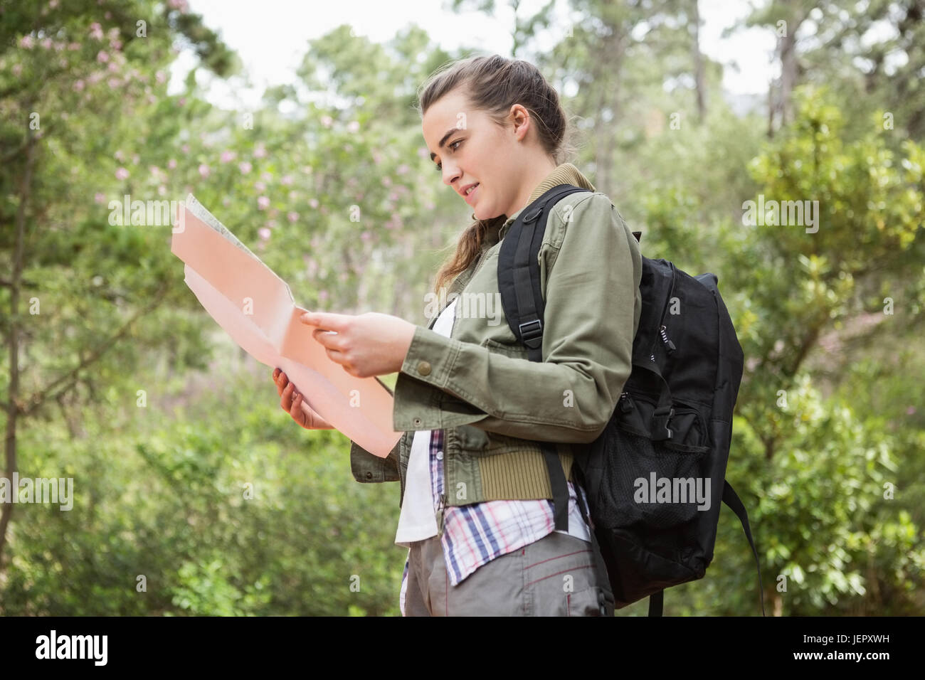 Woman with map and backpack Stock Photo - Alamy