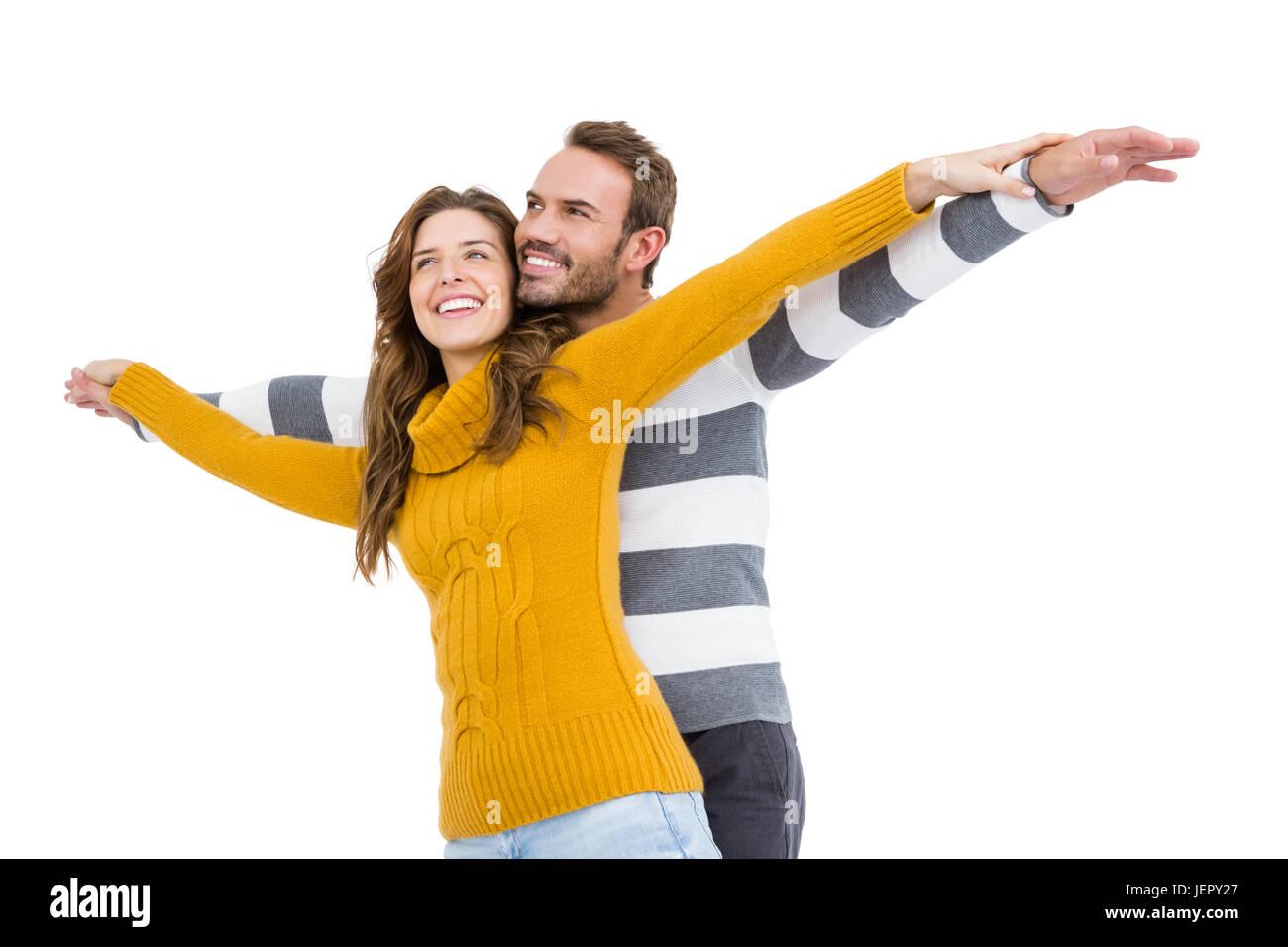Young couple standing with arms outstretched Stock Photo - Alamy