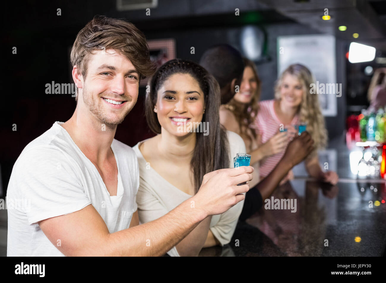 Group of friends having shots Stock Photo - Alamy