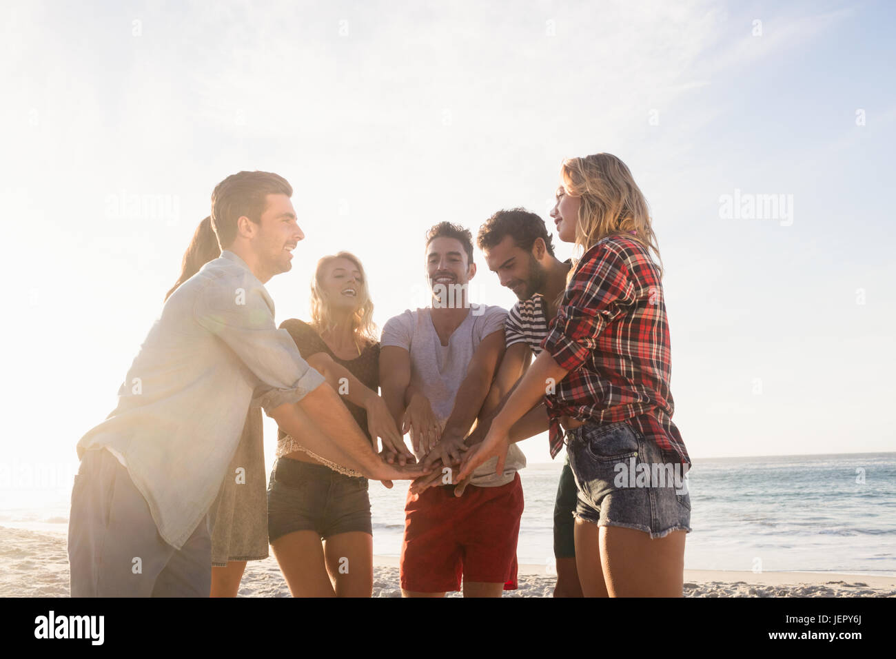 Happy friends gathering hands Stock Photo - Alamy