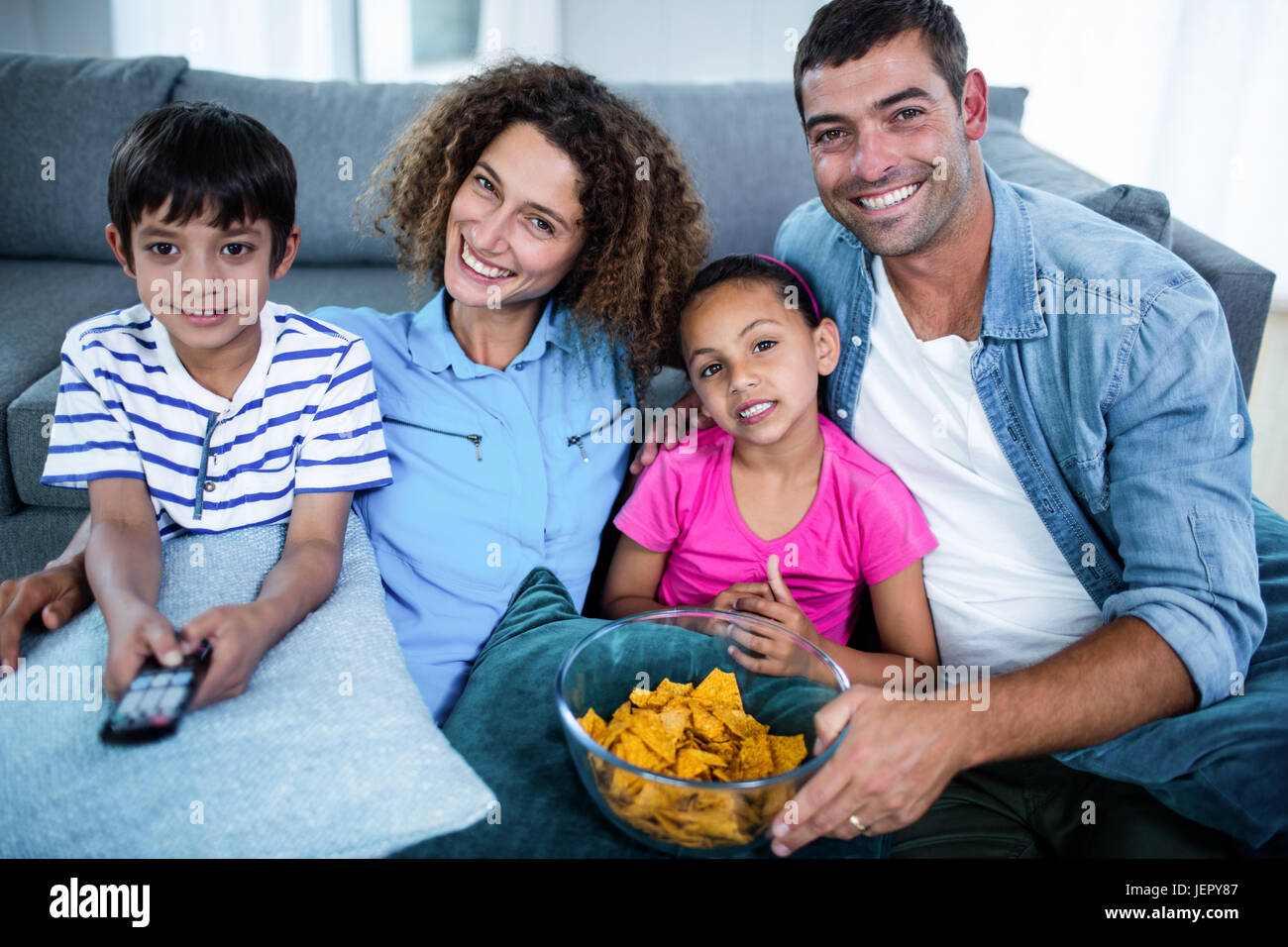 Portrait of family watching match together Stock Photo - Alamy