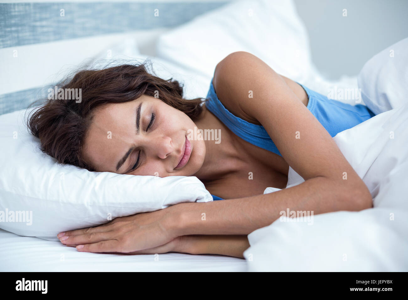 Young woman sleeping on bed Stock Photo - Alamy