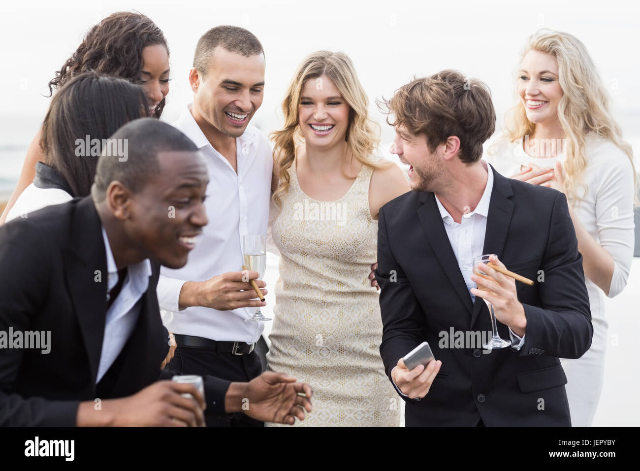 Well dressed people looking smartphone Stock Photo - Alamy
