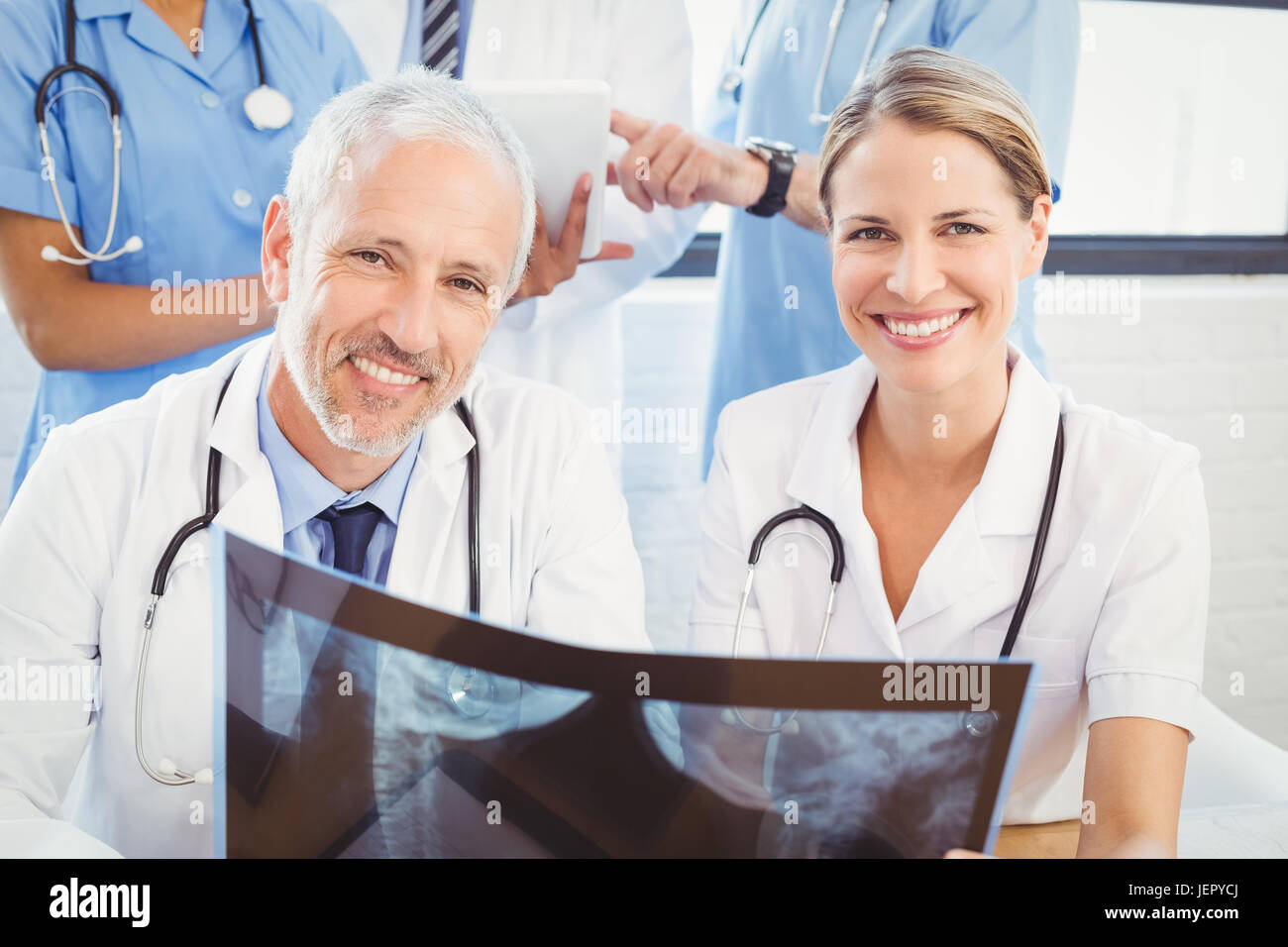 Two doctors holding an x-ray report Stock Photo - Alamy