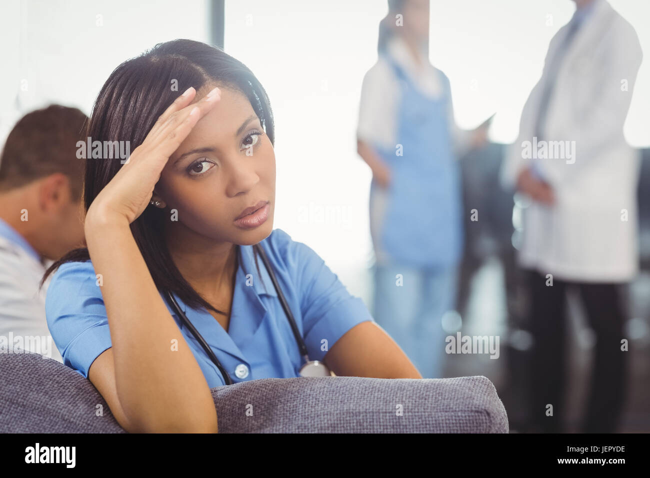 Tensed doctor sitting on hi-res stock photography and images - Alamy