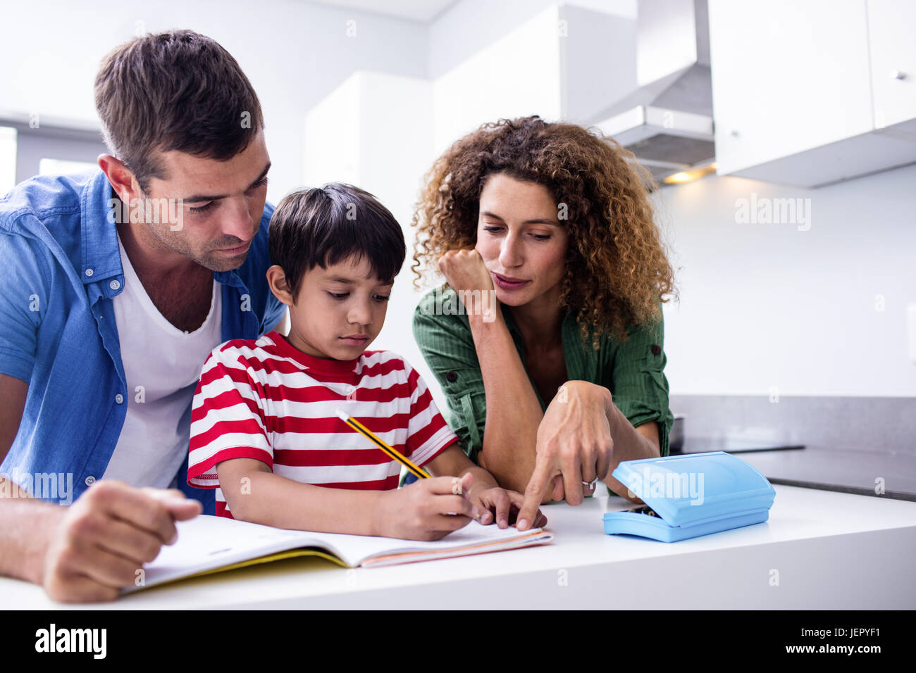 Parents helping studying hi-res stock photography and images - Alamy