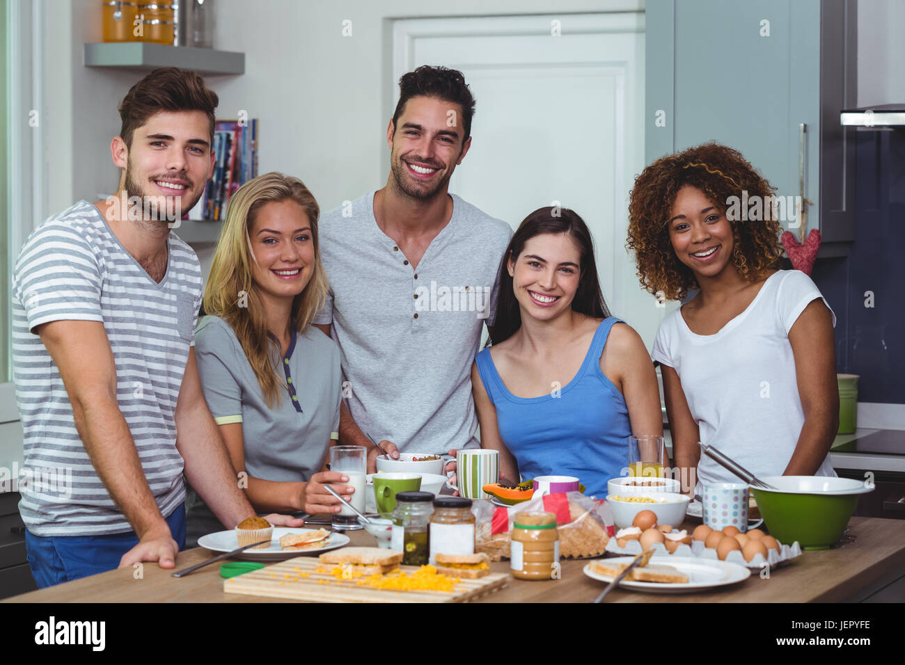 Cheerful female friends standing table hi-res stock photography and ...