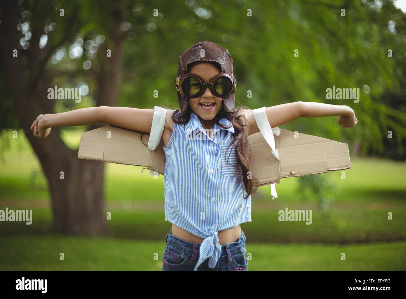 Young girl pretending to fly Stock Photo - Alamy