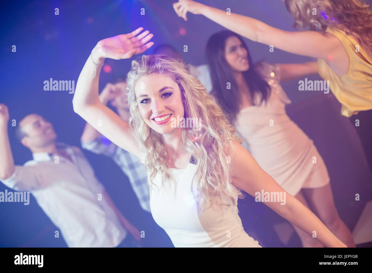 Happy friends dancing cheerfully Stock Photo - Alamy