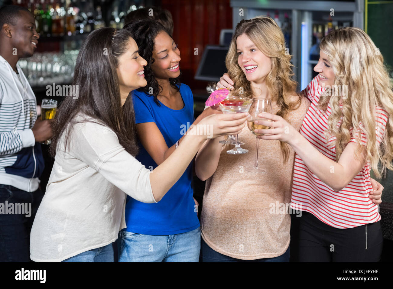 Friends drinking cocktails together Stock Photo - Alamy