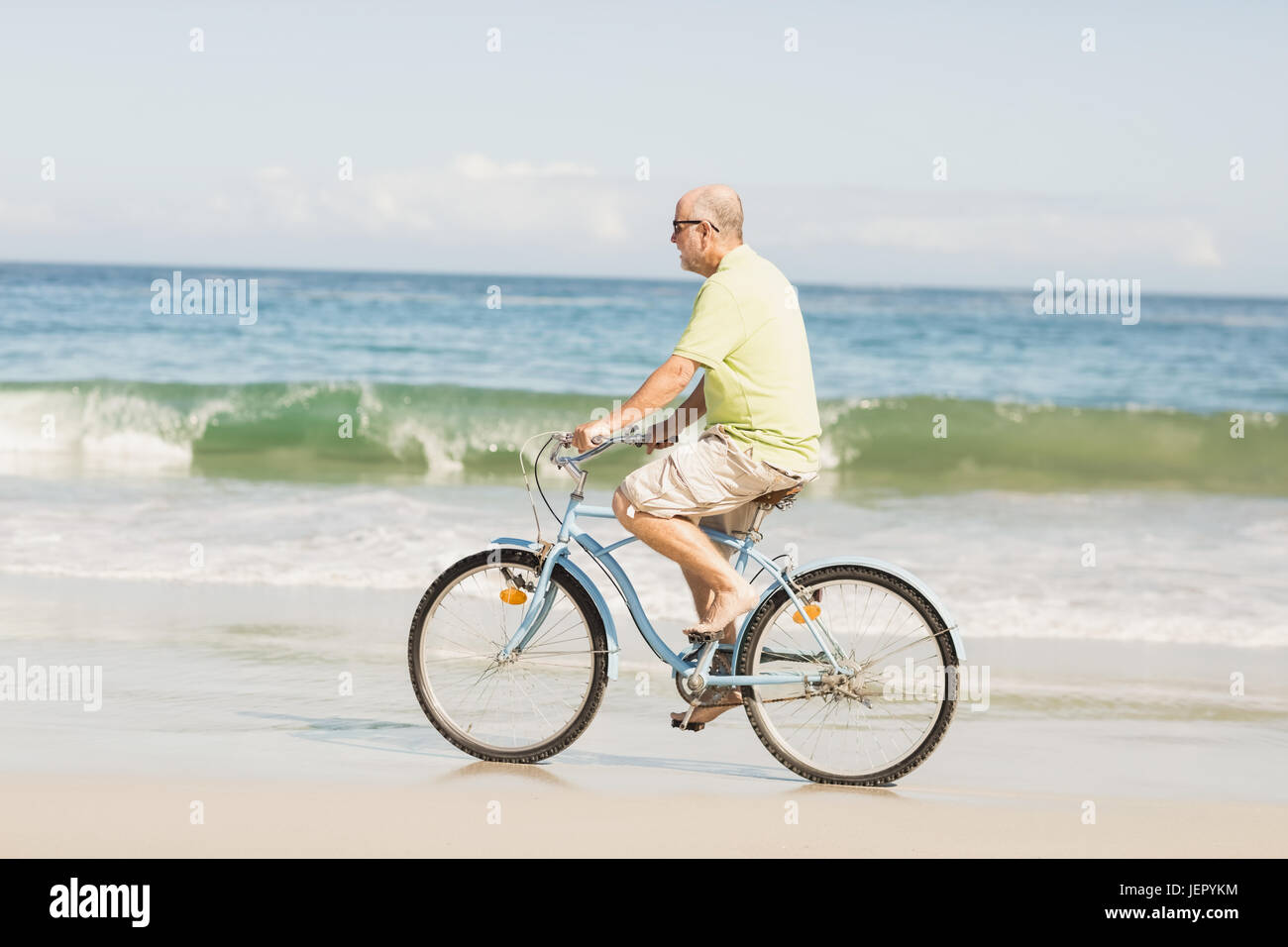 Smiling senior man riding bike Stock Photo - Alamy