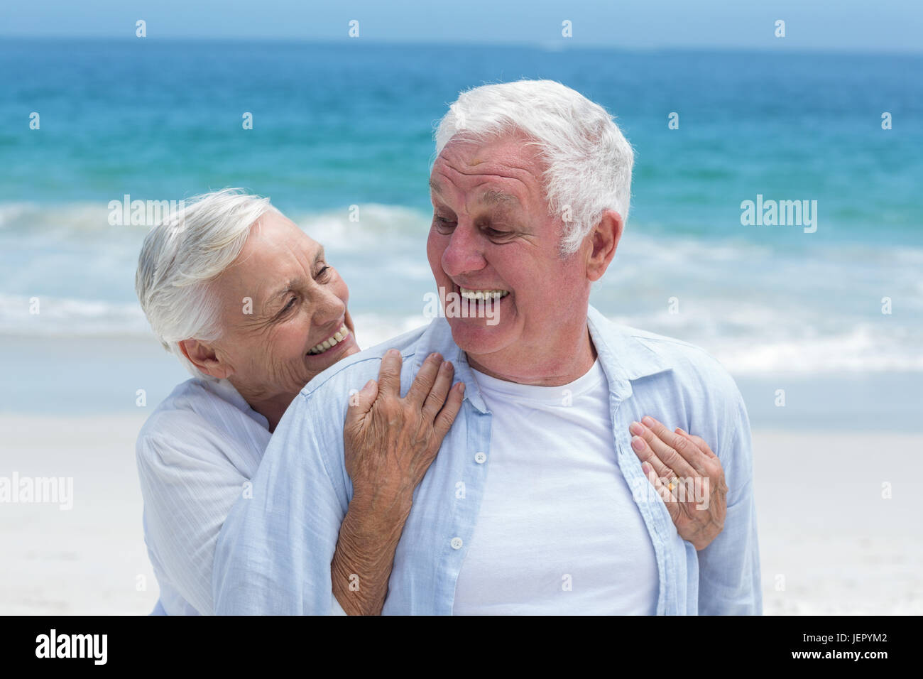Senior couple embracing arms hi-res stock photography and images - Alamy