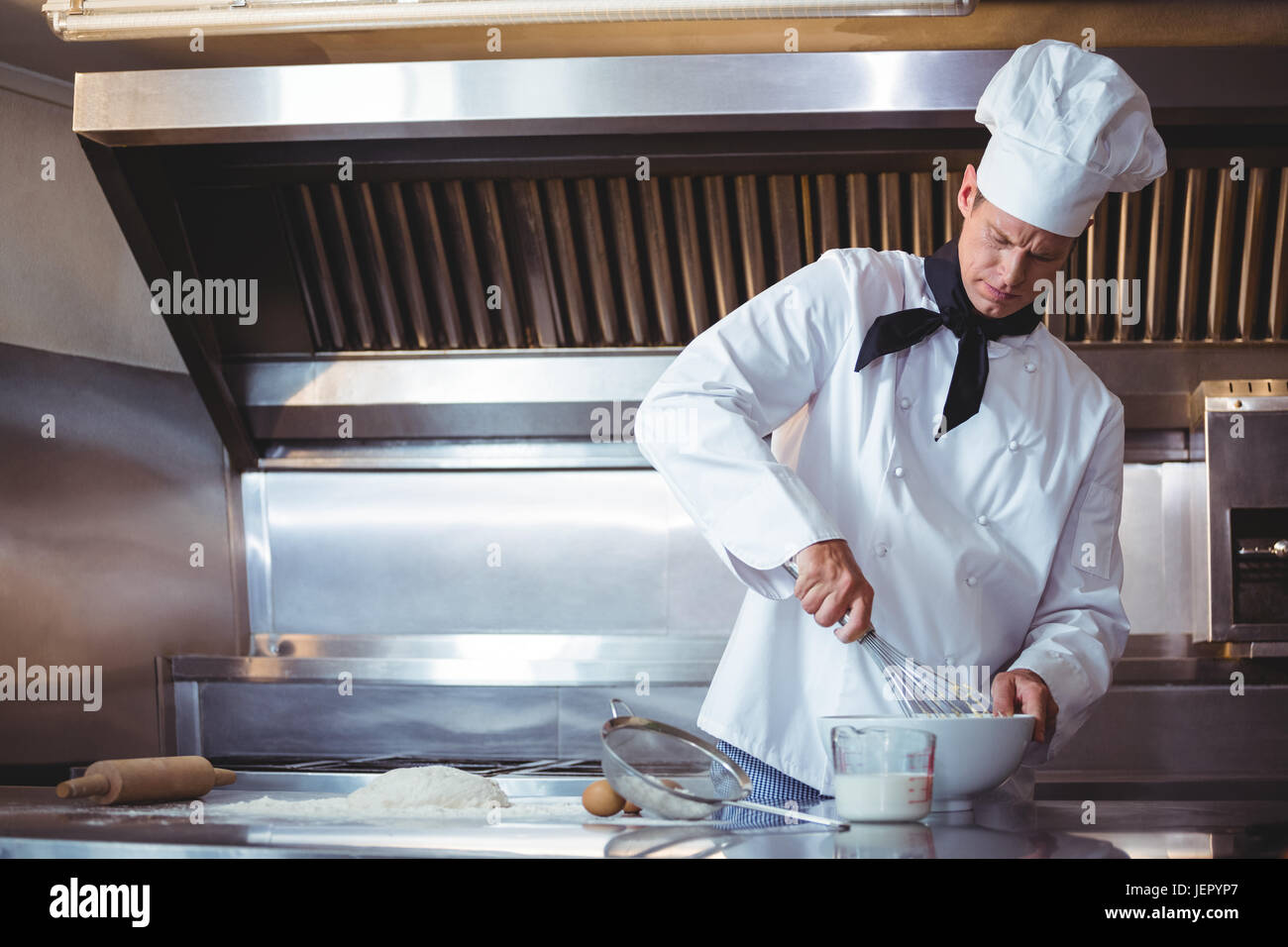 Focused chef preparing a cake Stock Photo - Alamy