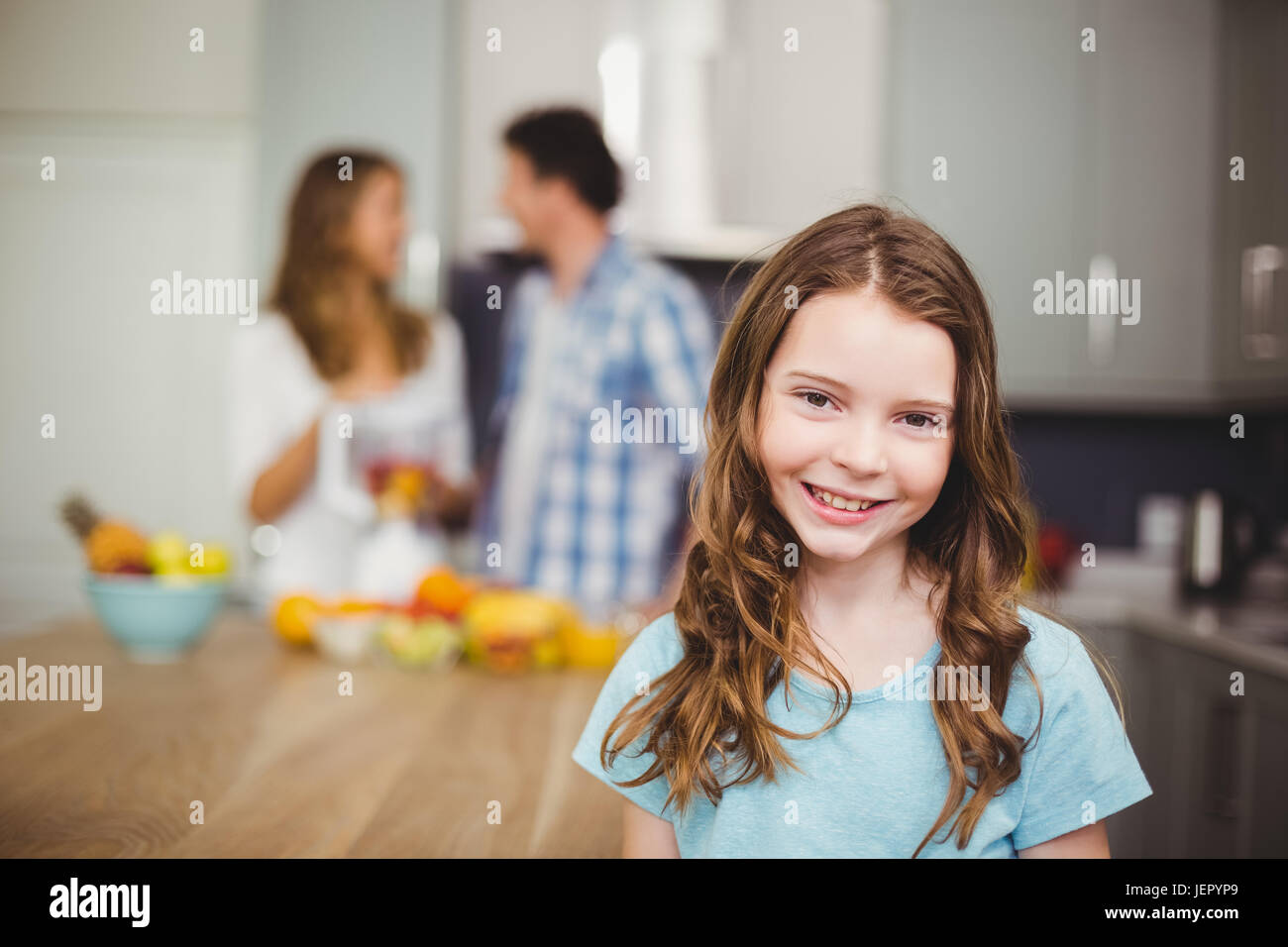 Portrait of smiling girl in kitchen Stock Photo - Alamy