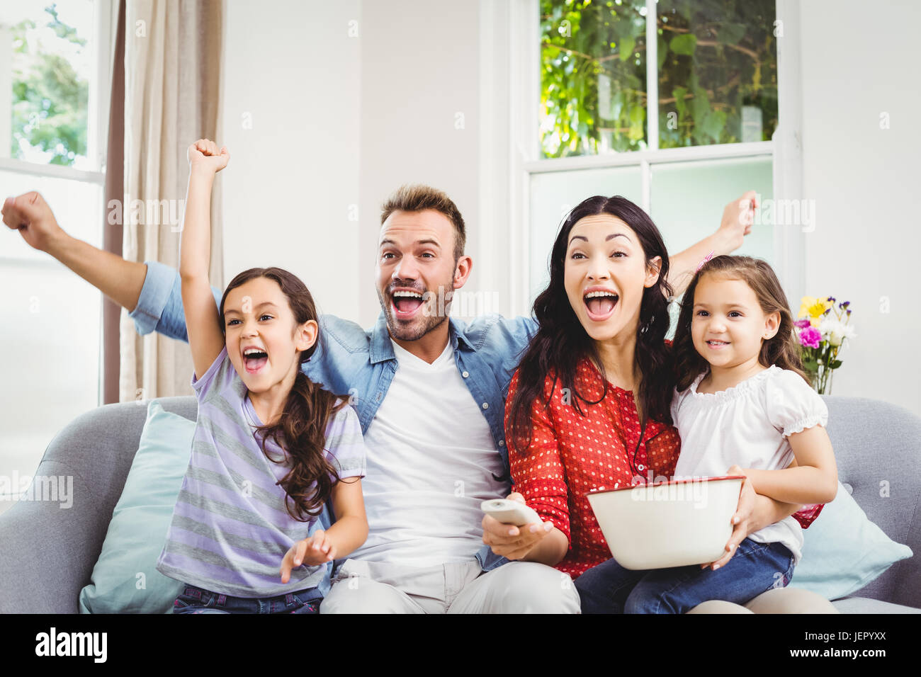 Family cheering watching tv hi-res stock photography and images - Alamy