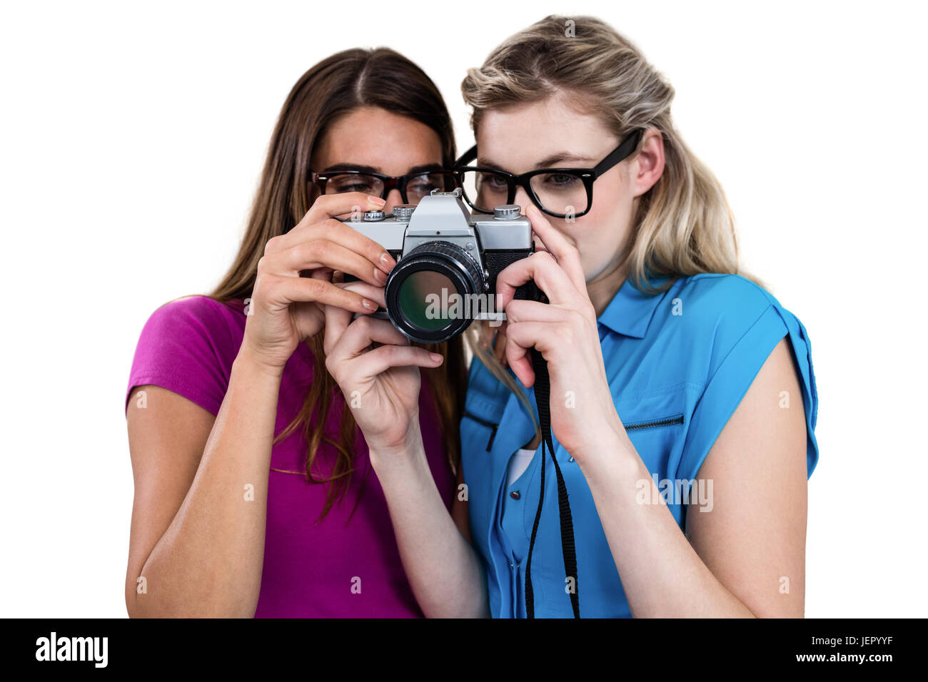 Female friends holding digital camera Stock Photo - Alamy