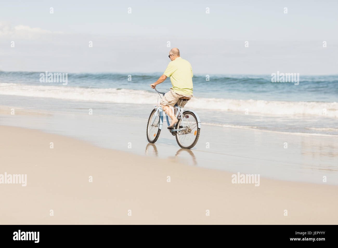 Smiling senior man riding bike Stock Photo - Alamy