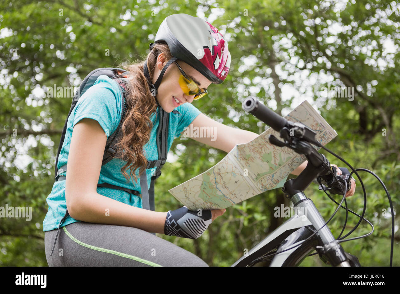 Woman checking the map Stock Photo - Alamy