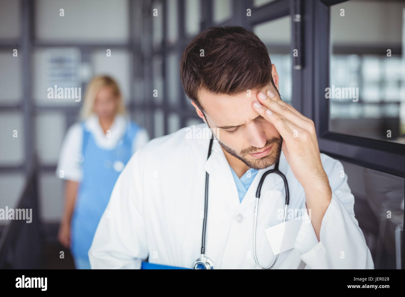Male doctor suffering from headache Stock Photo - Alamy